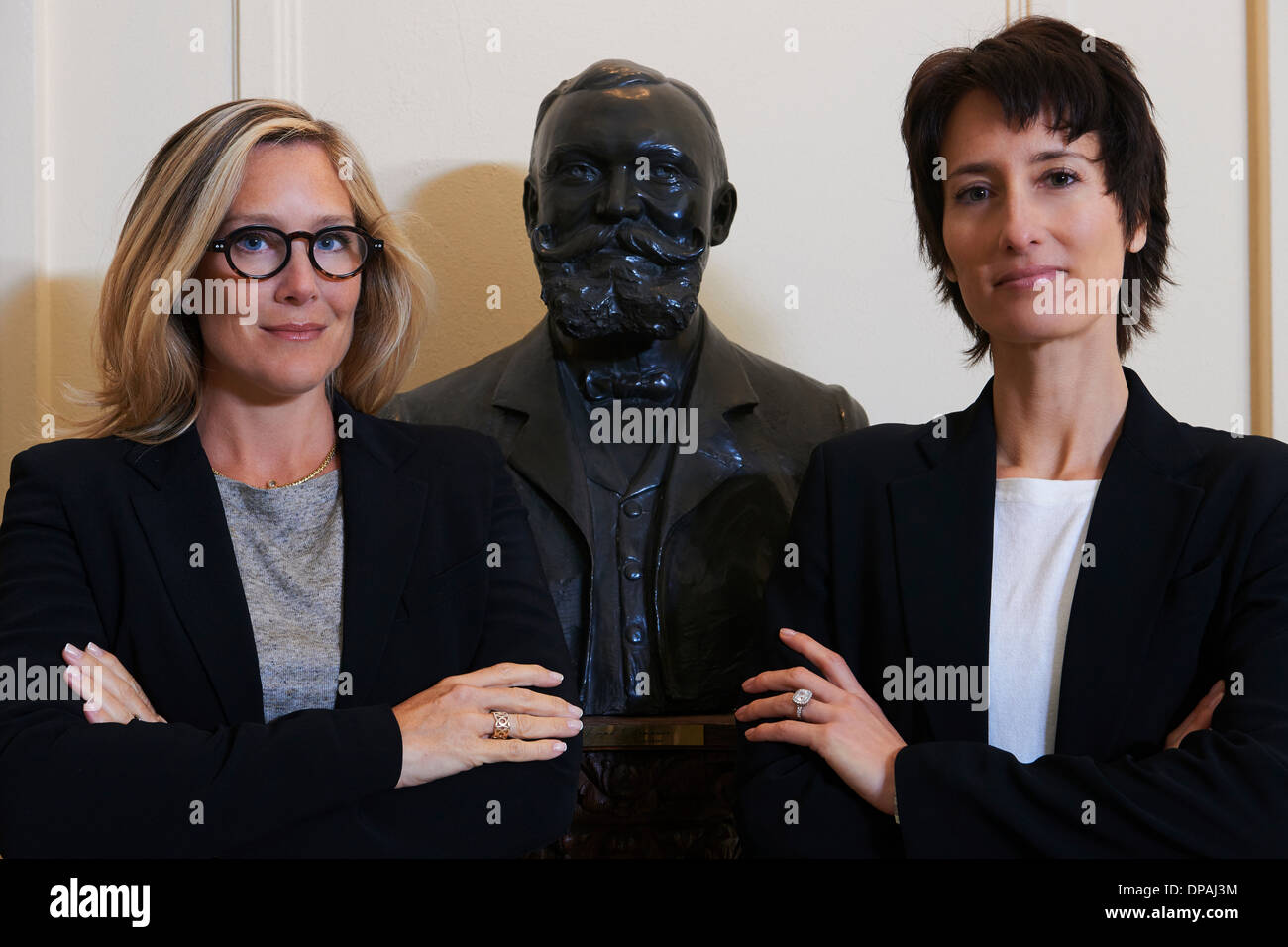 Portrait of confident professional women next to statue Stock Photo - Alamy