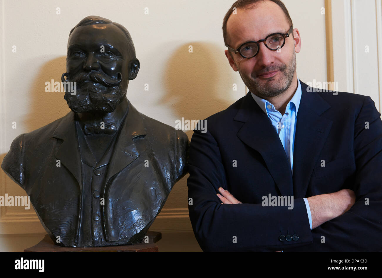 Portrait of confident professional man next to statue Stock Photo - Alamy