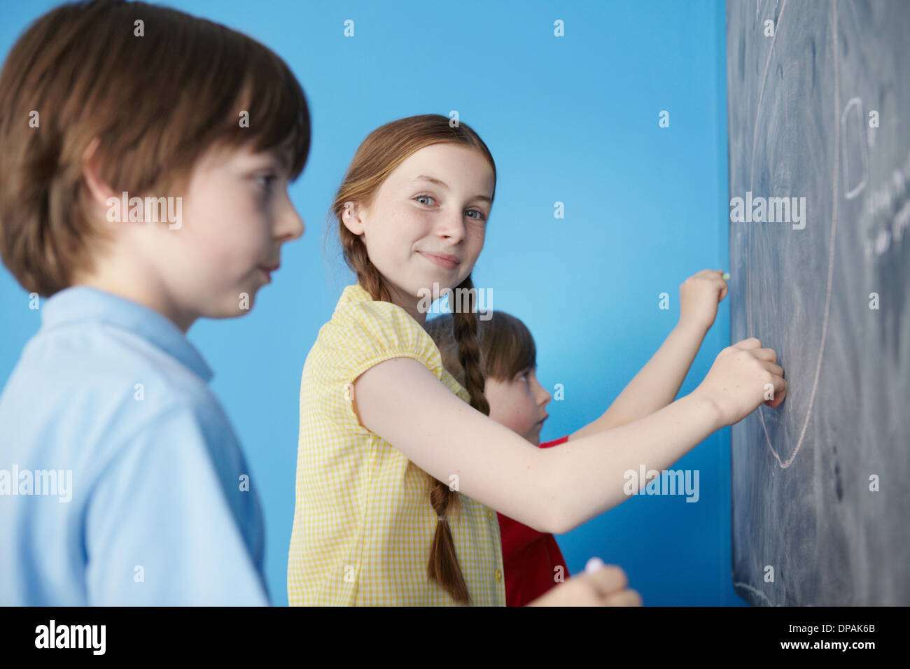 Children writing on blackboard hi-res stock photography and images - Alamy