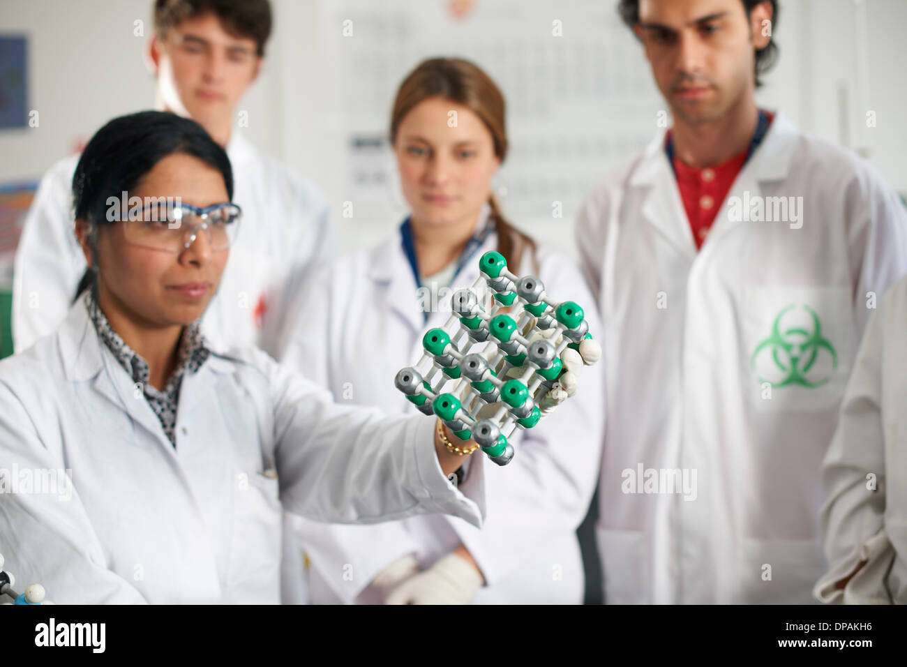 Chemistry teacher and students holding molecular model Stock Photo - Alamy