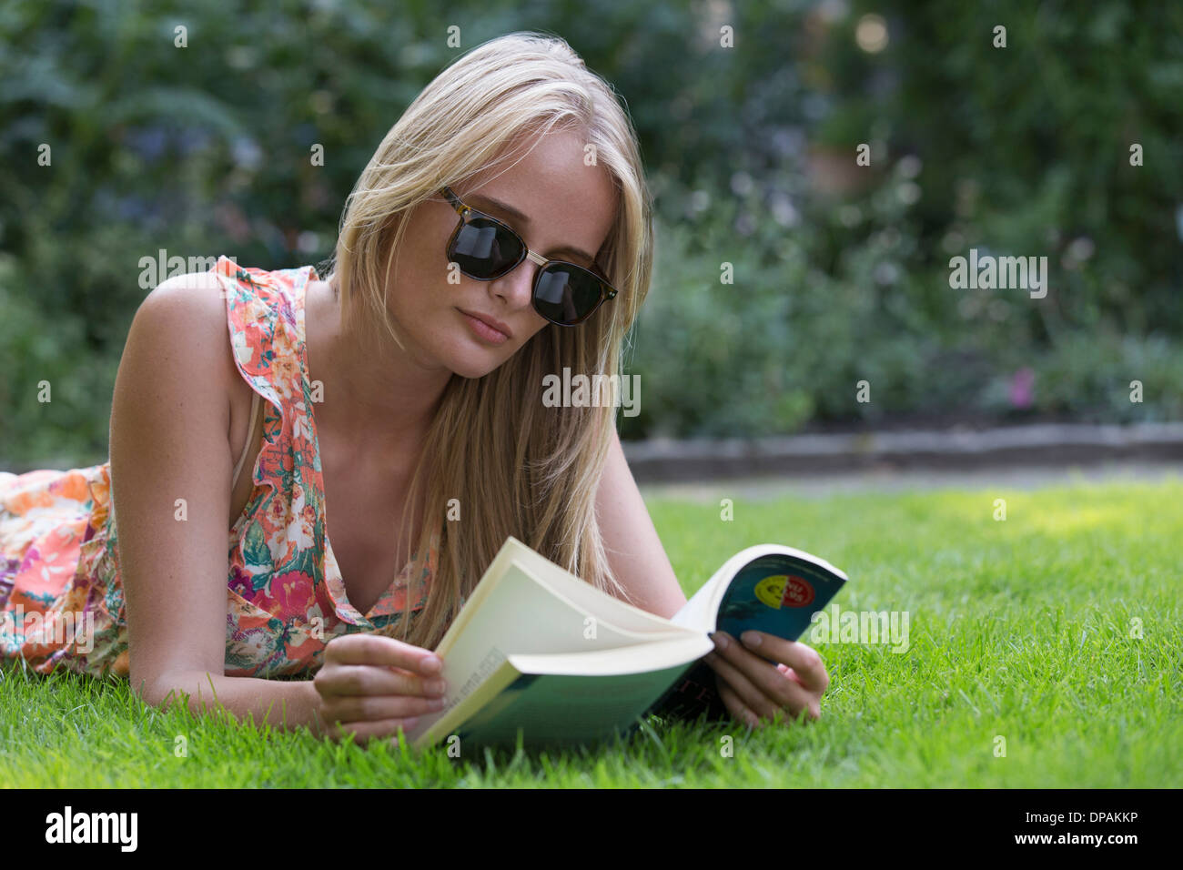 Young woman reading book Stock Photo - Alamy