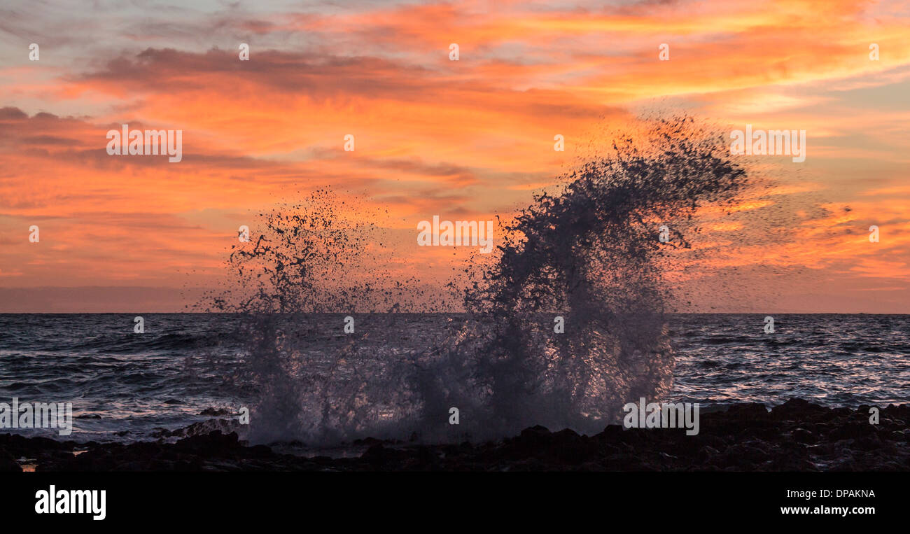 Water splashing on rocks at sunrise on the shore of Sandy Beach in ...