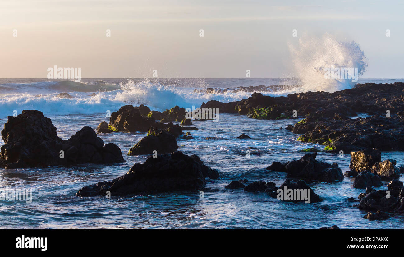 Ocean splashing on the rocks at early dawn at Sandy Beach on Oahu ...