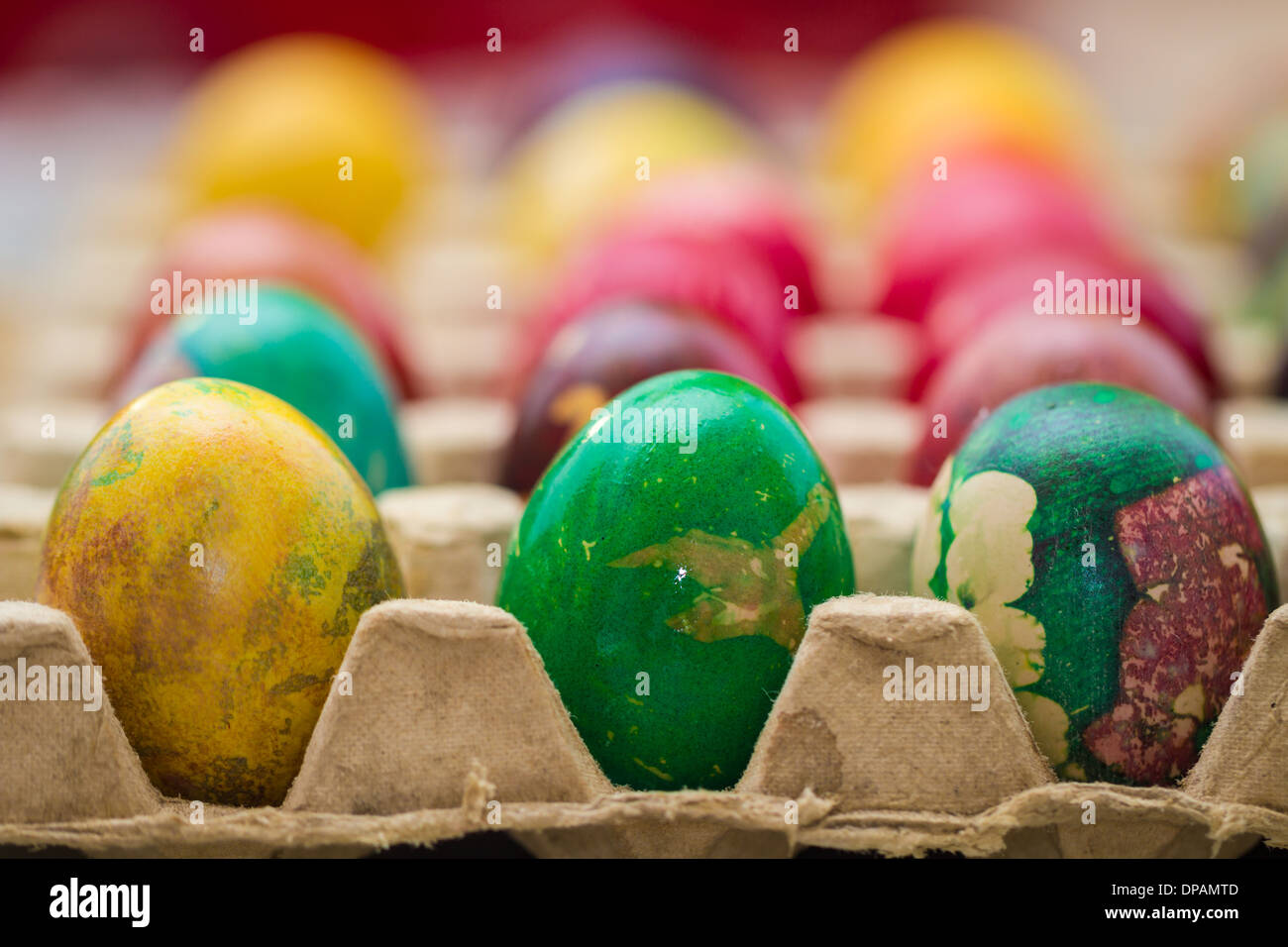 Easter eggs in various colors placed in row Stock Photo - Alamy