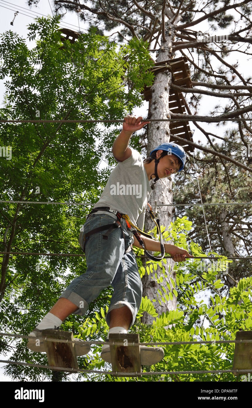 Teenage boy at the ropes course Stock Photo - Alamy