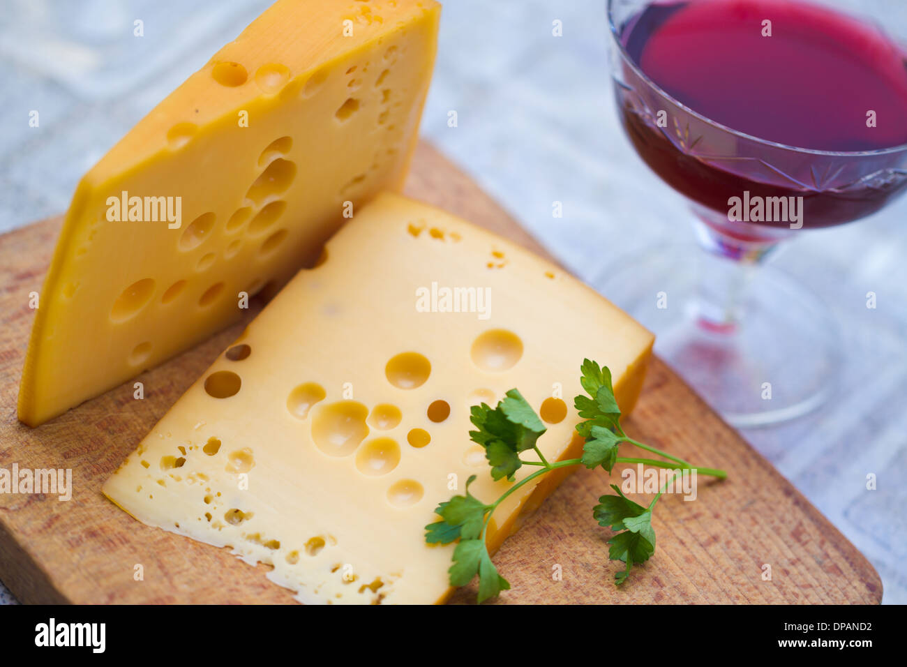 Emental cheese and wine shoot with short DOF Stock Photo - Alamy