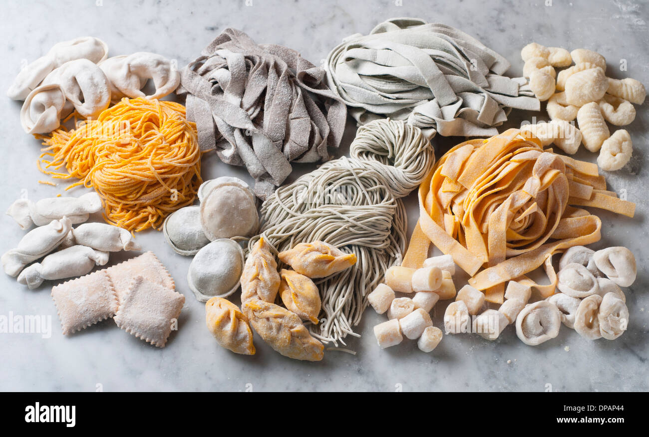 different types and flavors of fresh pasta on marble table Stock Photo ...