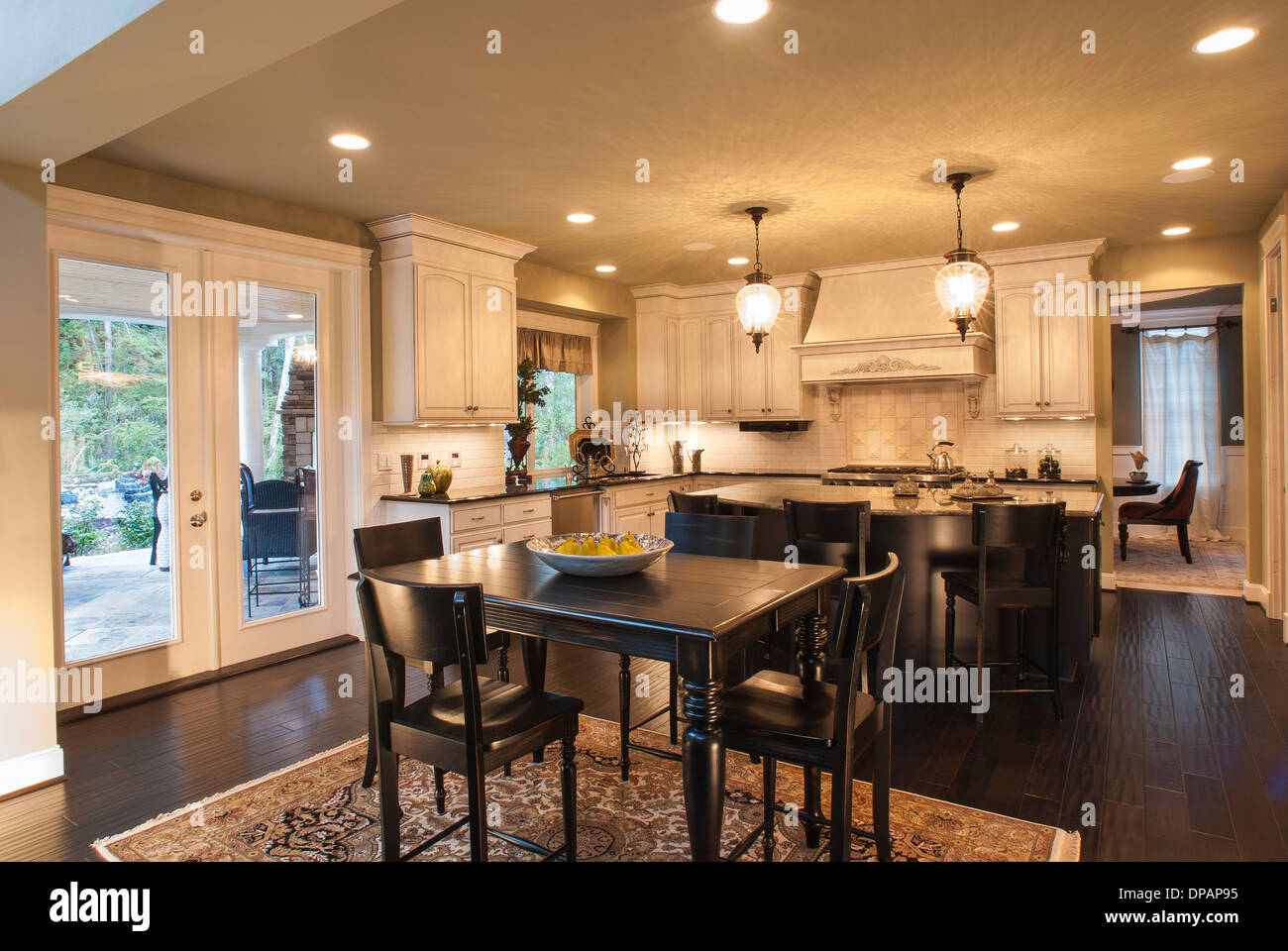 Broad view of kitchen in high-end luxury home showing table and chairs ...