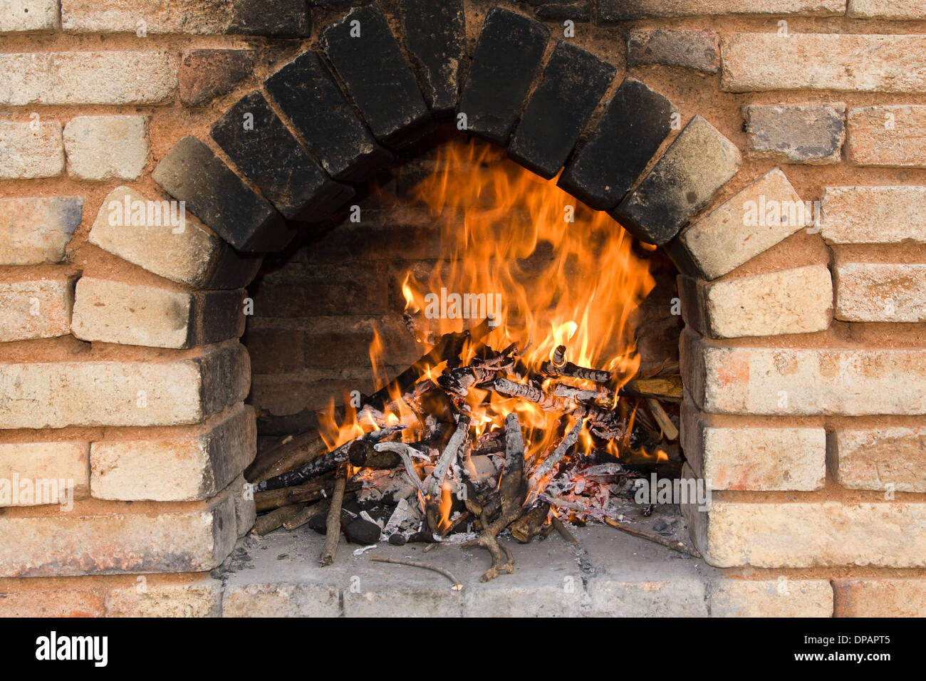 Fireplace with fire and embers Stock Photo - Alamy