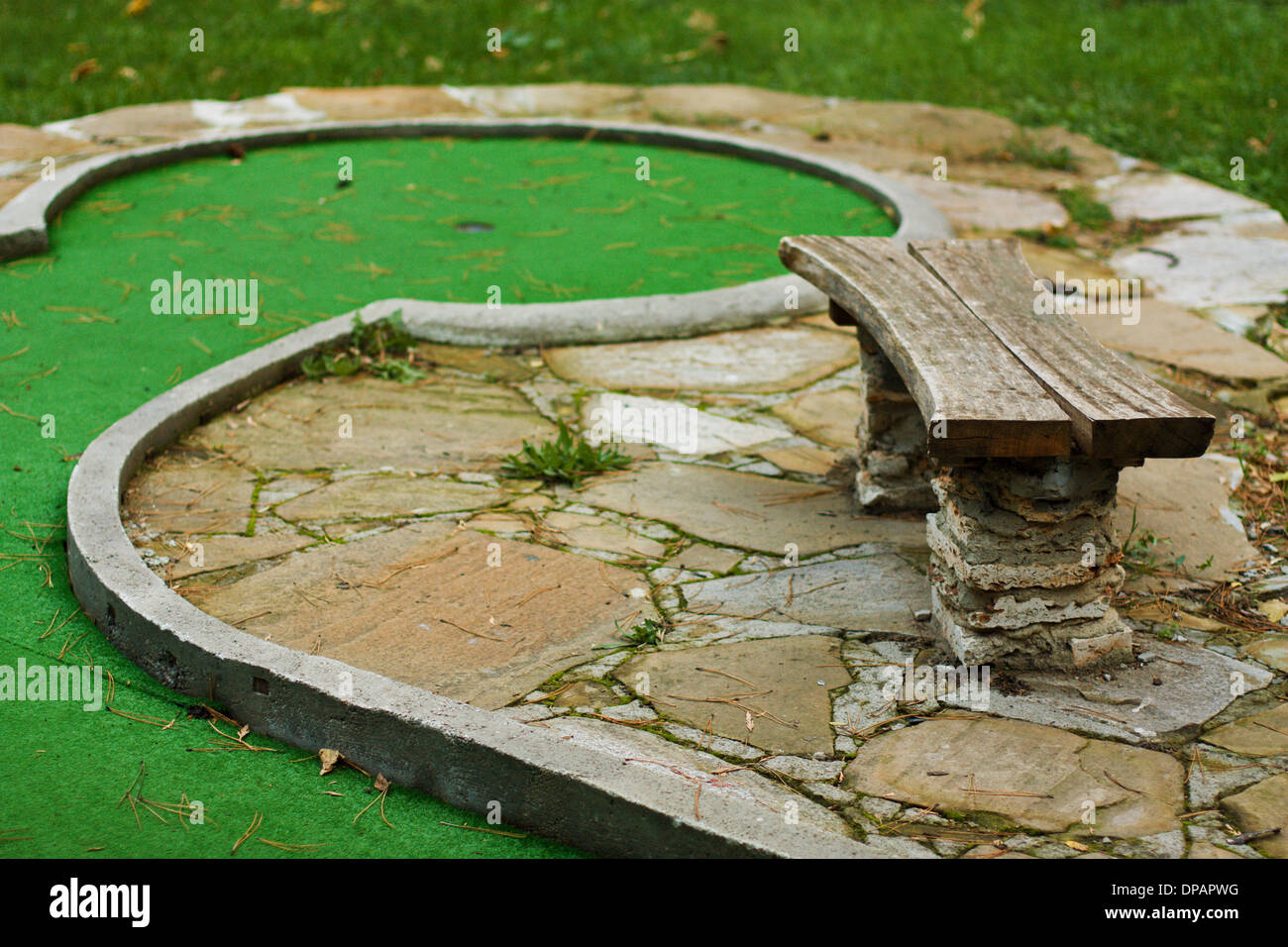 Outdoor green mini golf with bench near it Stock Photo - Alamy