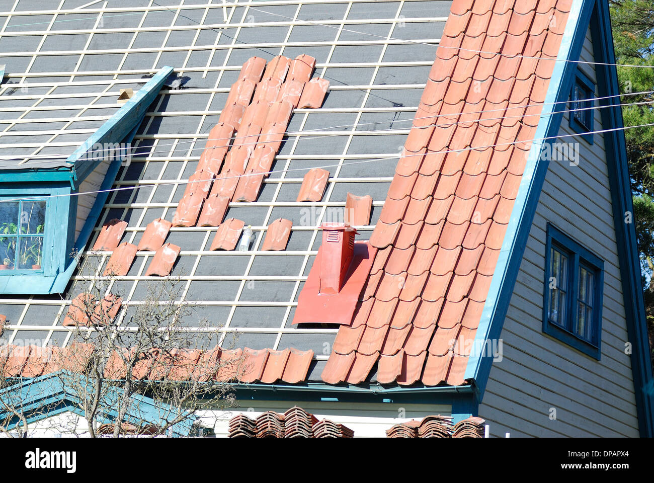 Covering roof with new tile Stock Photo - Alamy