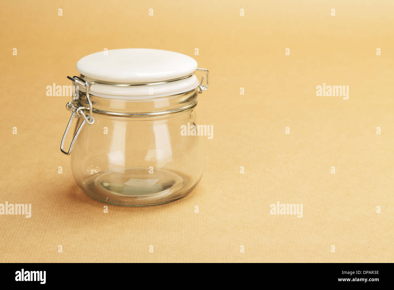 An empty jar with a white lid on a background of a wrapping paper Stock ...