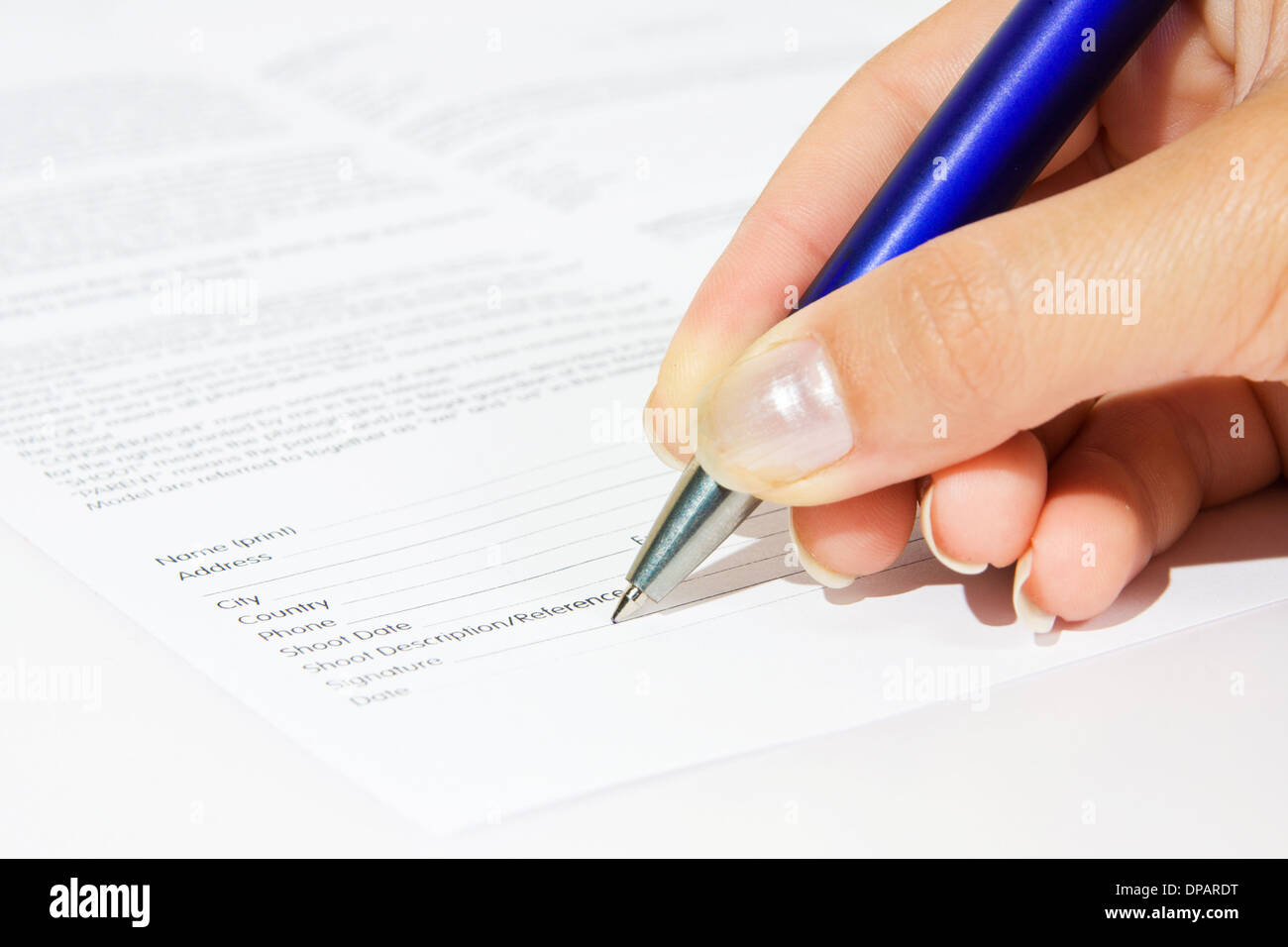 Signing contract closeup. Agreement with woman hand Stock Photo - Alamy