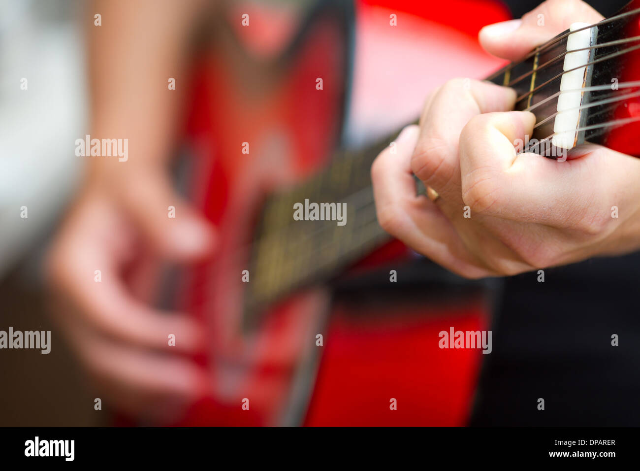 Guitarist playing jazz on red acoustic guitar Stock Photo - Alamy