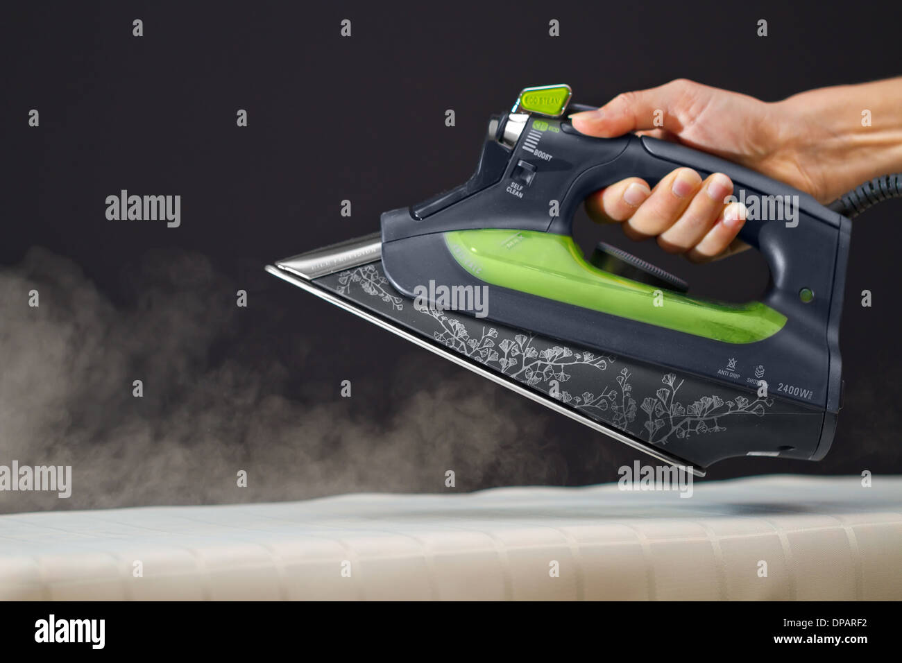 Woman ironing laundry with new ecologycal iron Stock Photo - Alamy