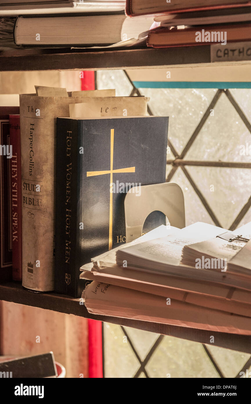 Bible on book shelf with window Stock Photo - Alamy