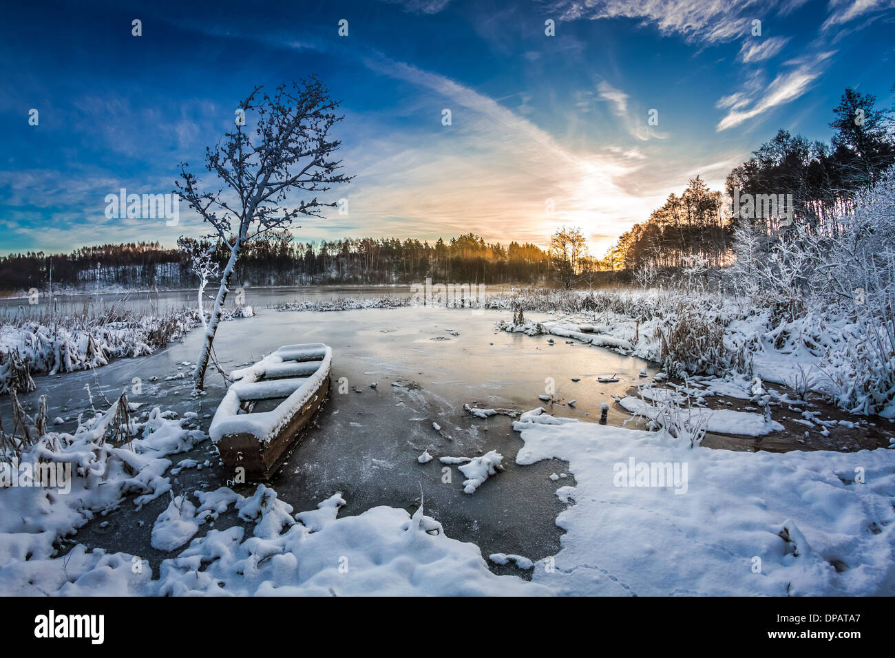 Frozen boat on the lake in winter at sunrise Stock Photo - Alamy