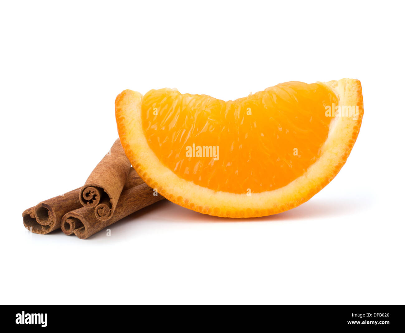 Orange fruit segment and cinnamon sticks isolated on white background ...