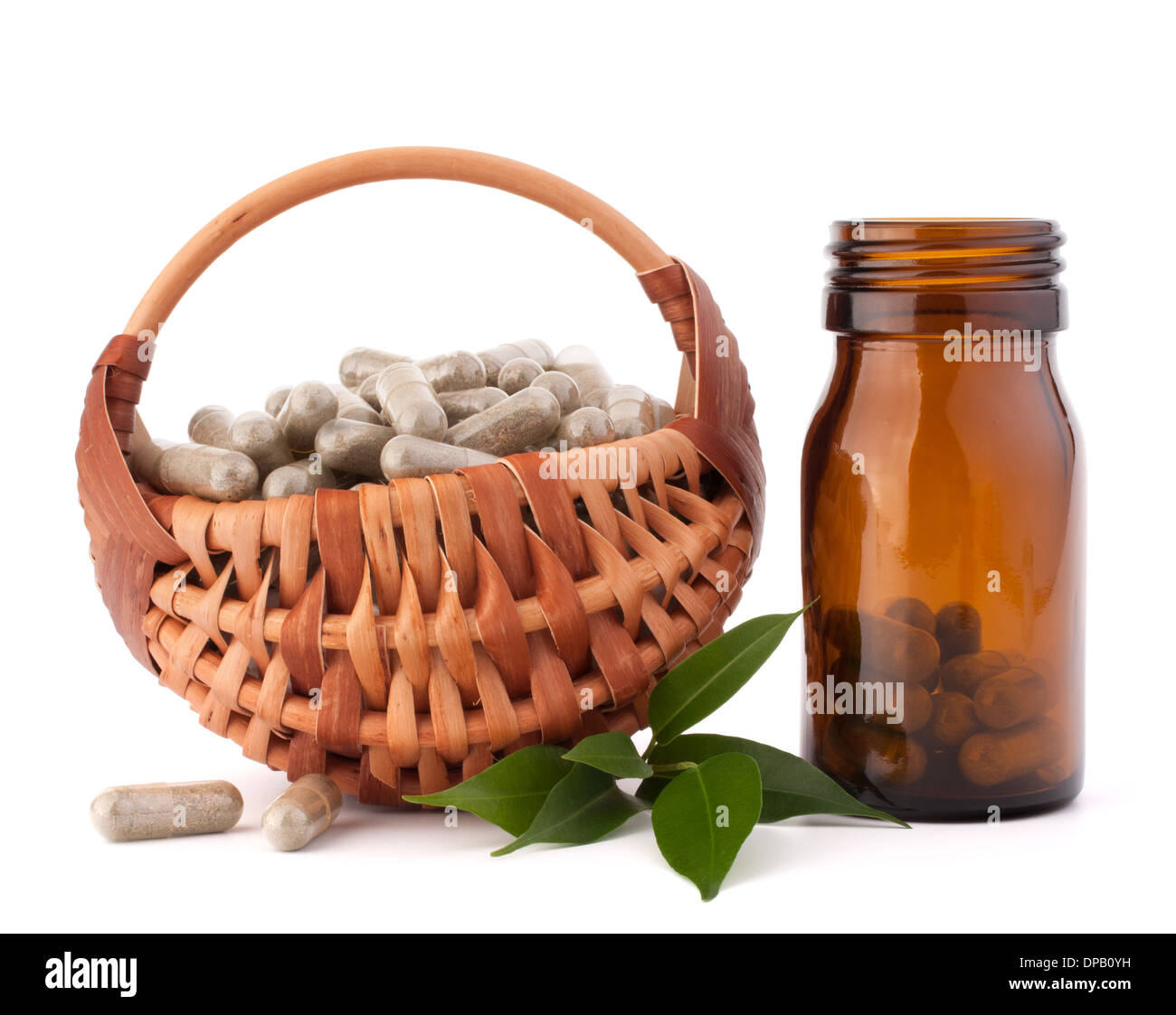 Herbal drug capsules in wicker basket isolated on white background ...