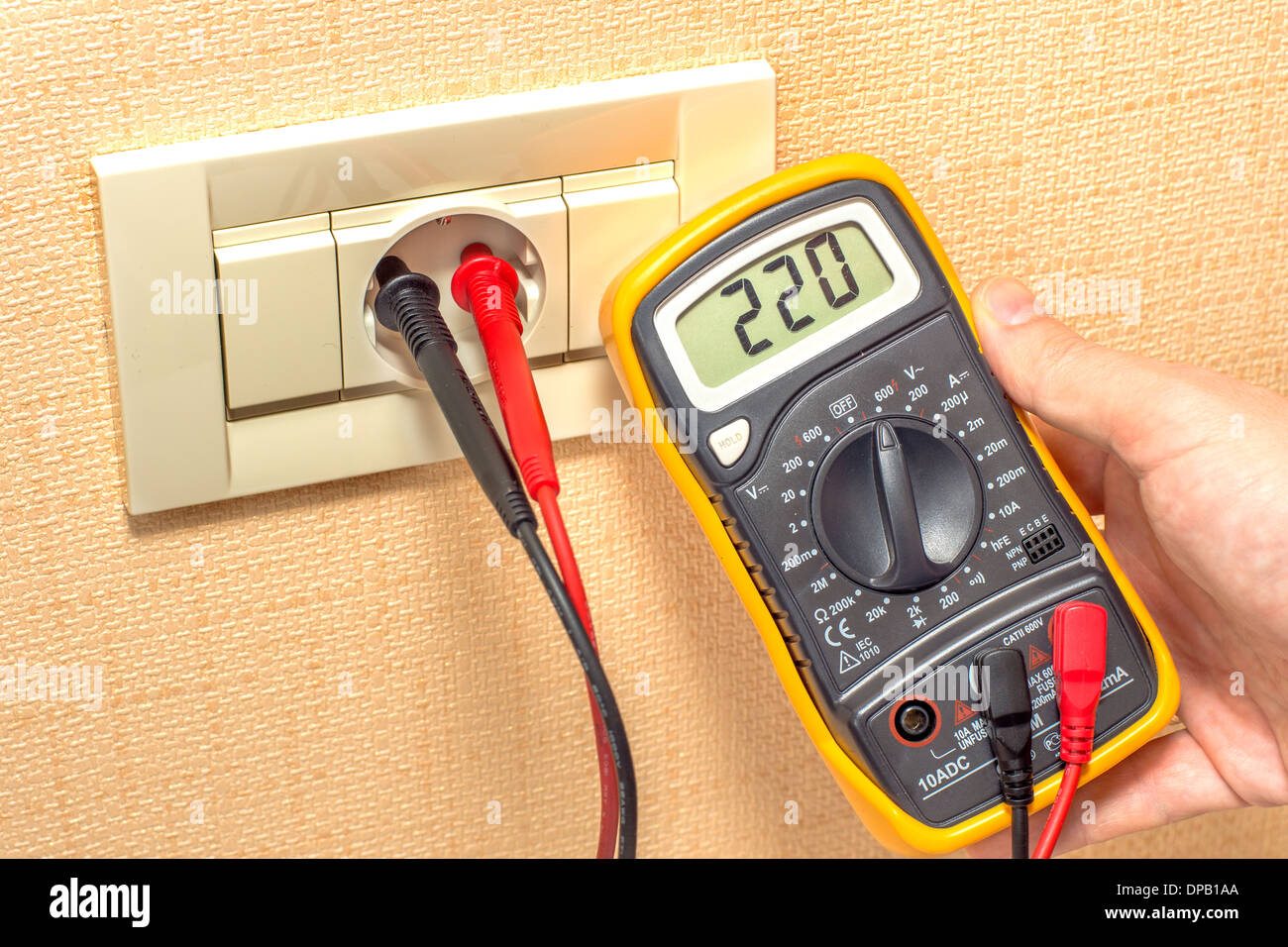 Metering socket voltage with digital multimeter Stock Photo - Alamy