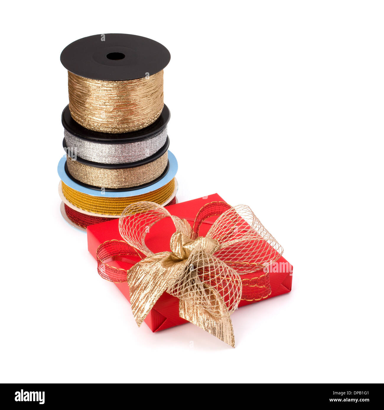 Festive gift box and wrapping ribbons isolated on white background ...