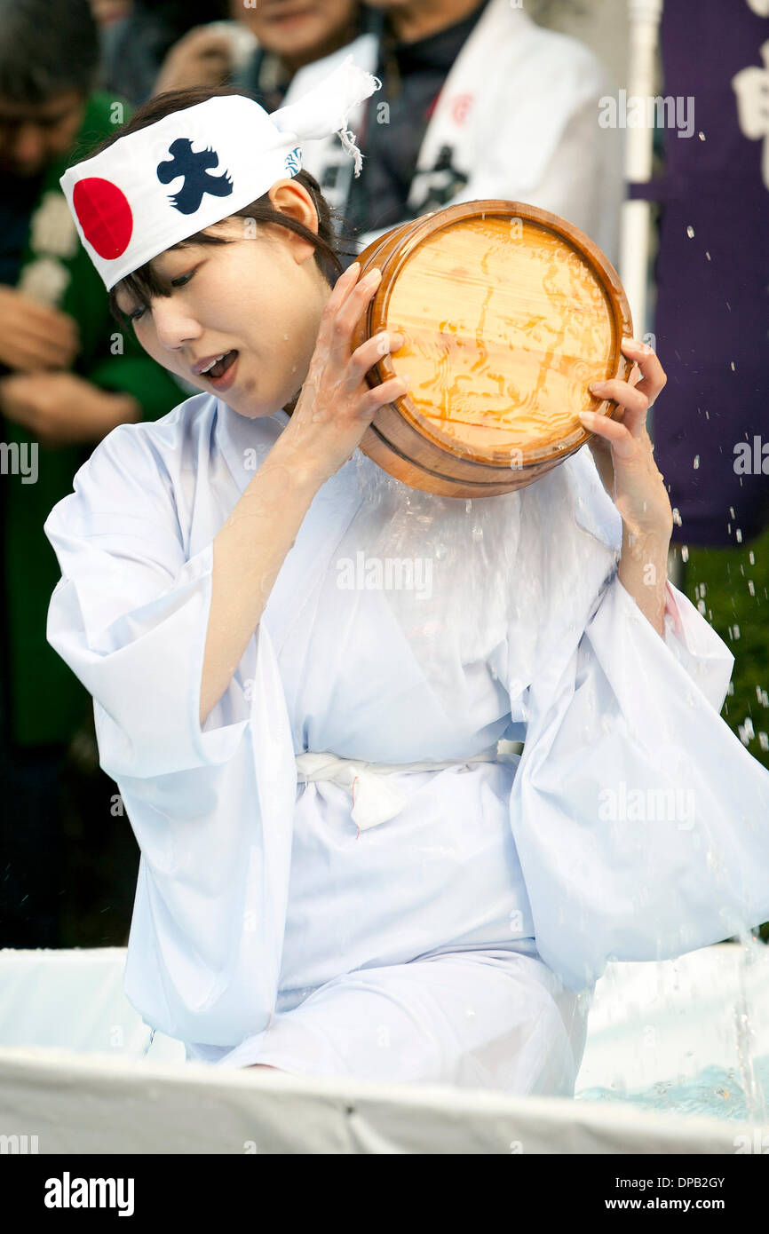 Tokyo, Japan. 11th Jan, 2014. A participant pours herself cold water ...