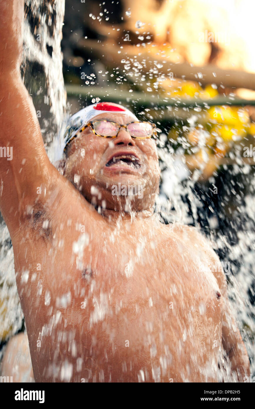 Tokyo, Japan. 11th Jan, 2014. A participant pours himself cold water ...