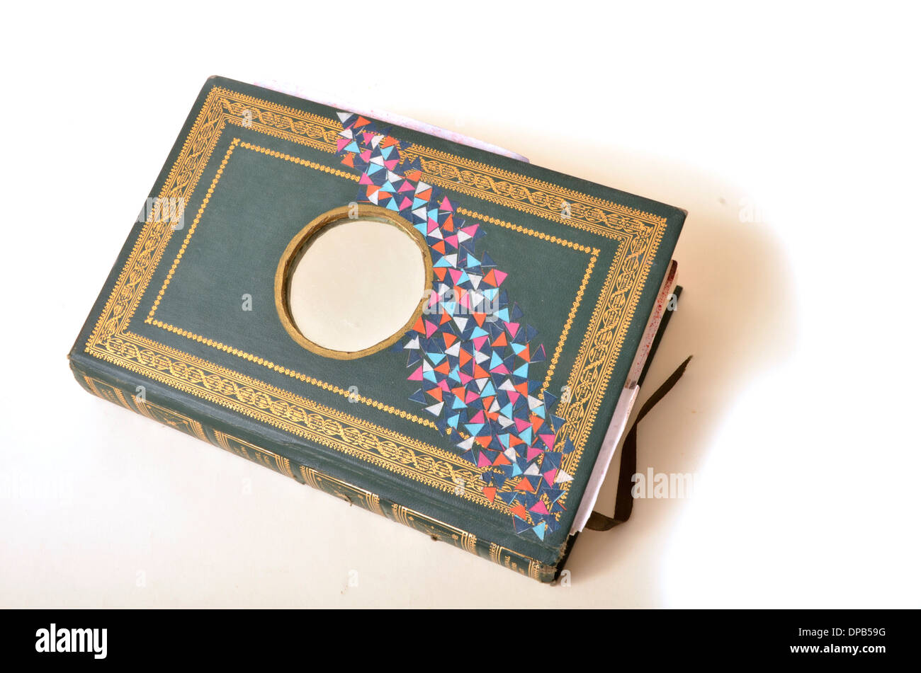Old book with mirror cutout and painted design Stock Photo - Alamy