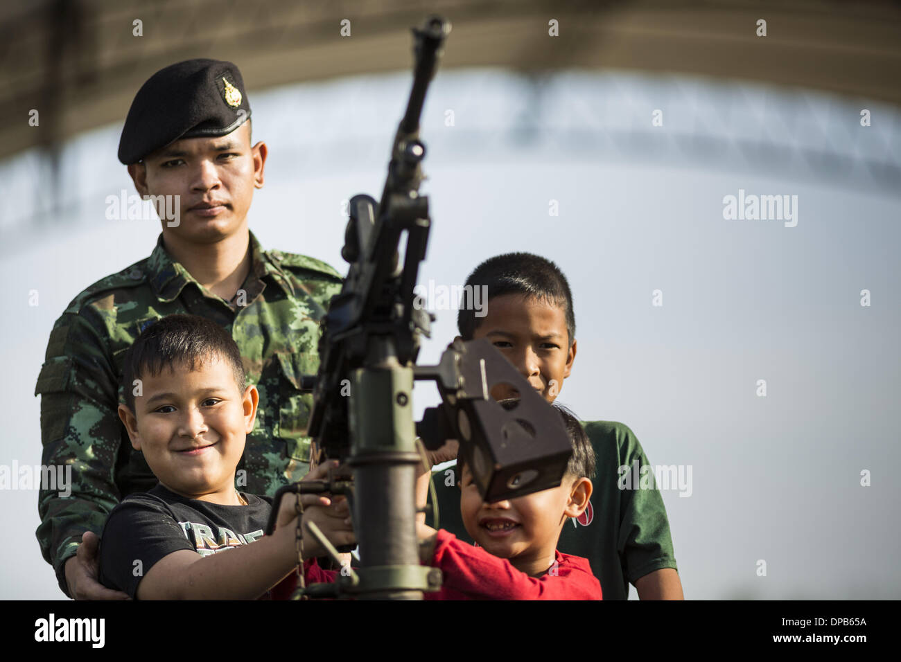 Bangkok, Thailand. 11th Jan, 2014. Thai children and a Thai soldier ...