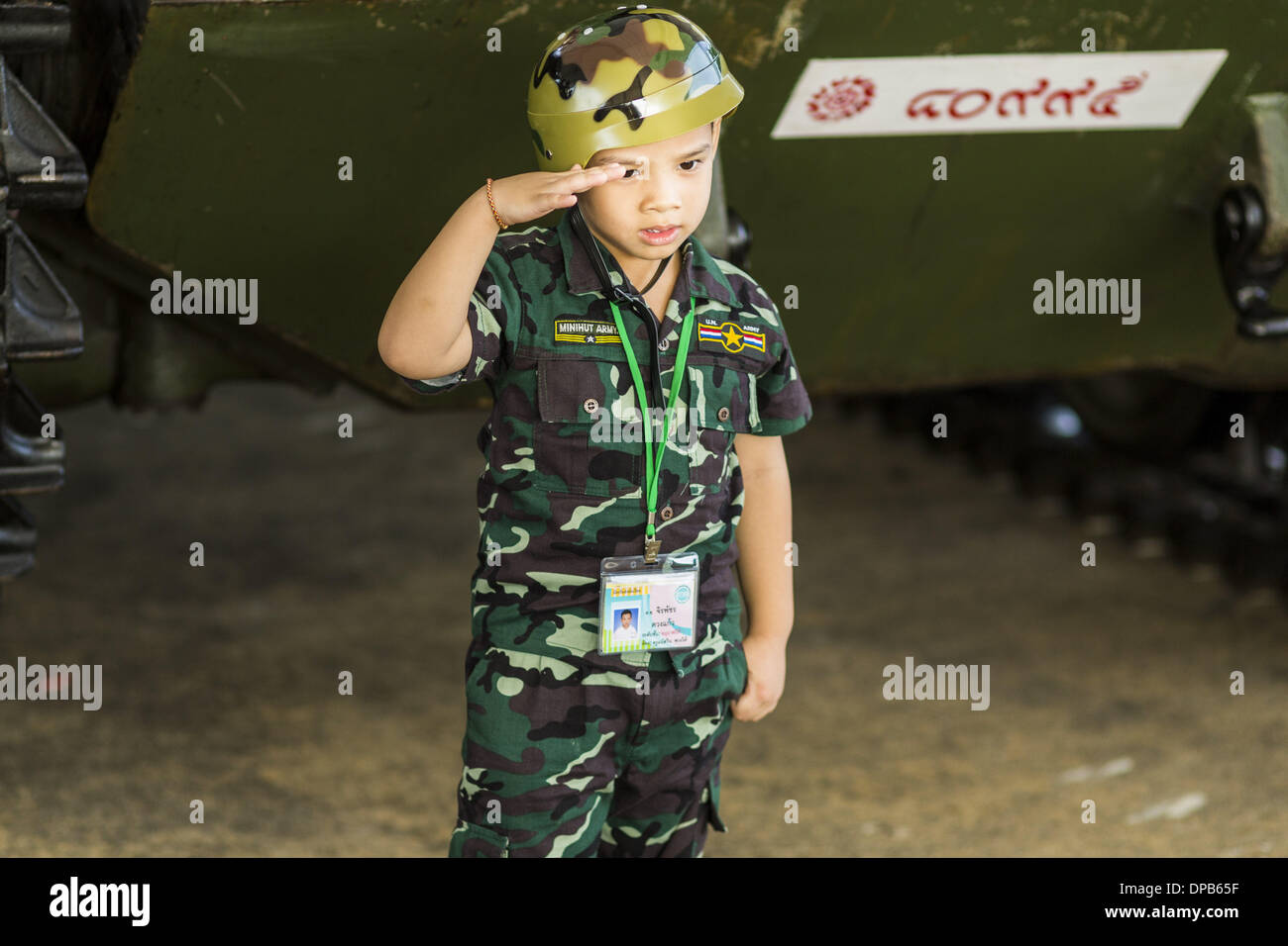 Bangkok, Thailand. 11th Jan, 2014. A boy dressed as a soldier salutes ...