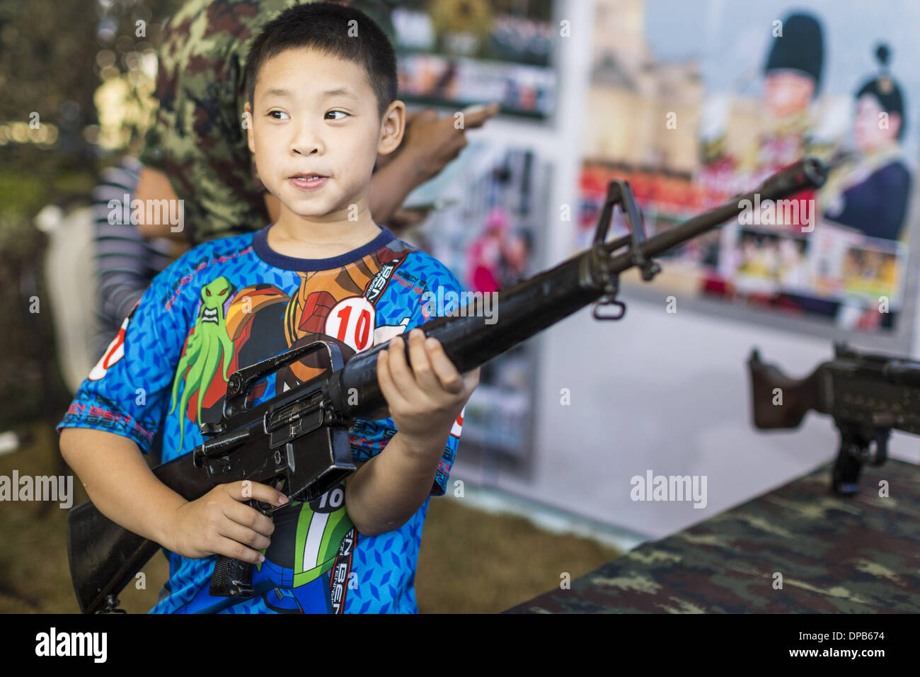 Bangkok, Thailand. 11th Jan, 2014. A Thai boy plays with a M16 Assault ...
