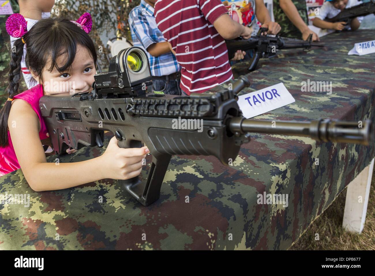 Bangkok, Thailand. 11th Jan, 2014. A Thai girl plays with a TAVOR ...