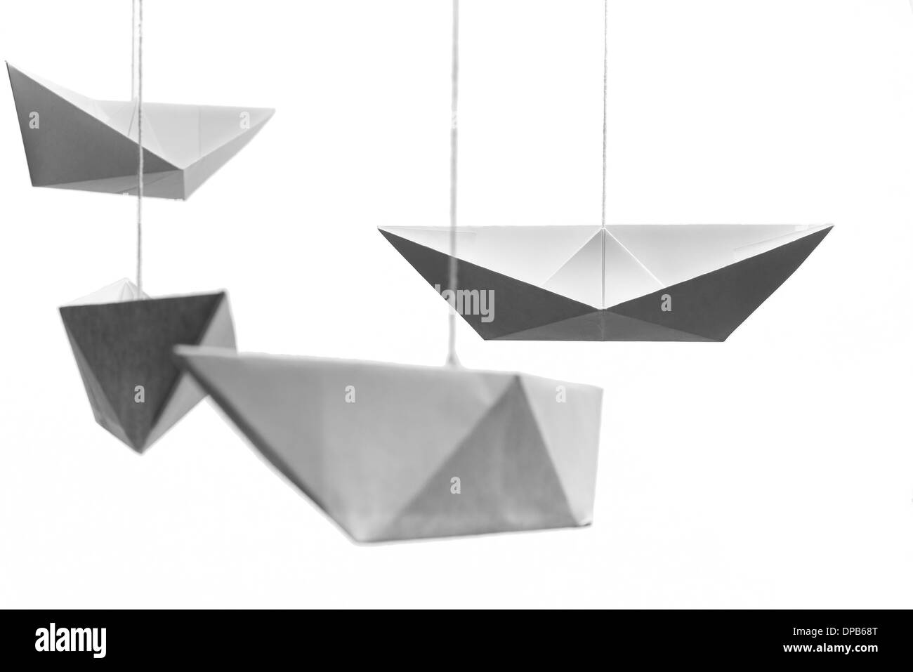 paper boats hung twine on white background Stock Photo - Alamy