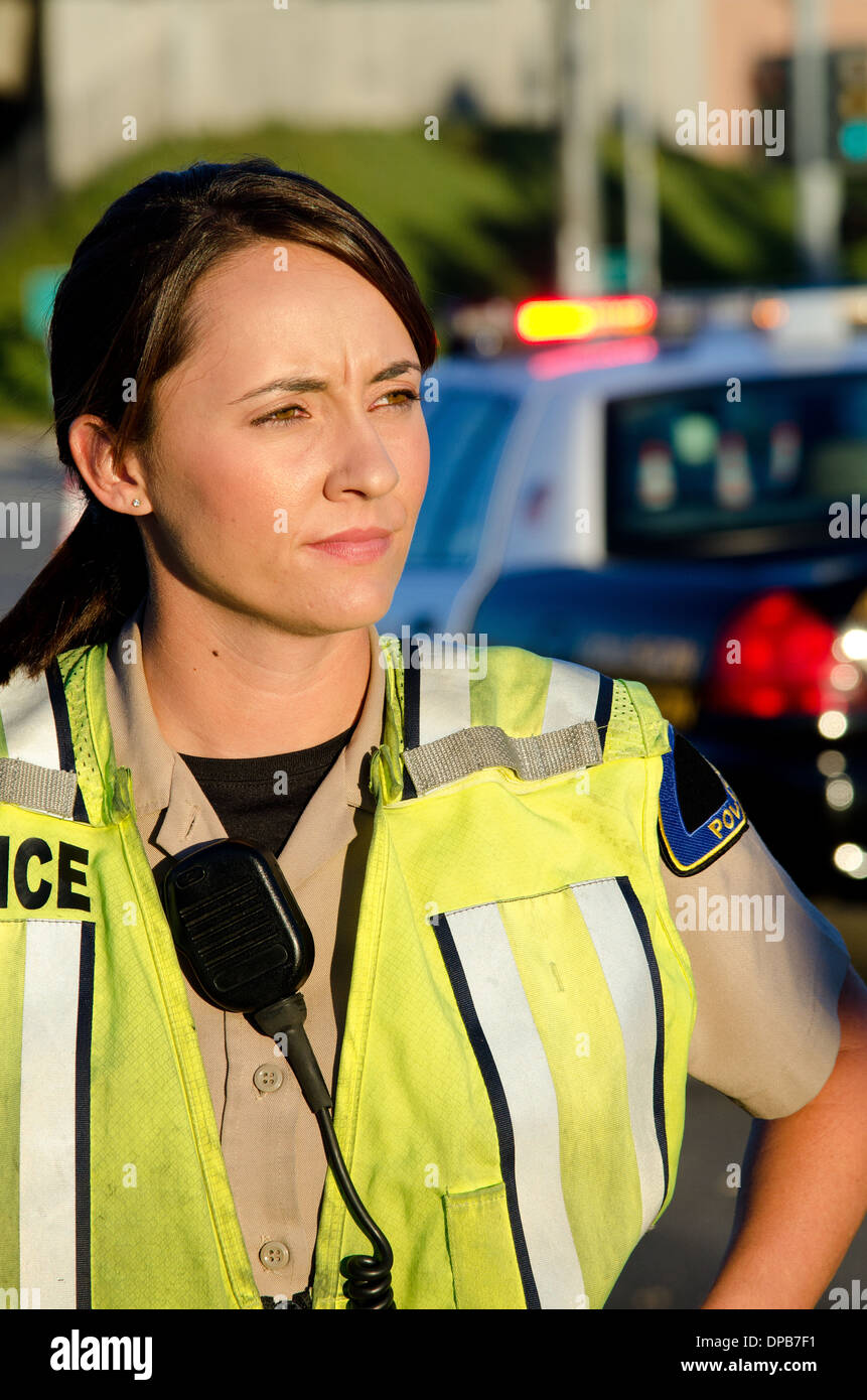 A female police officer staring and looking serious during a traffic ...