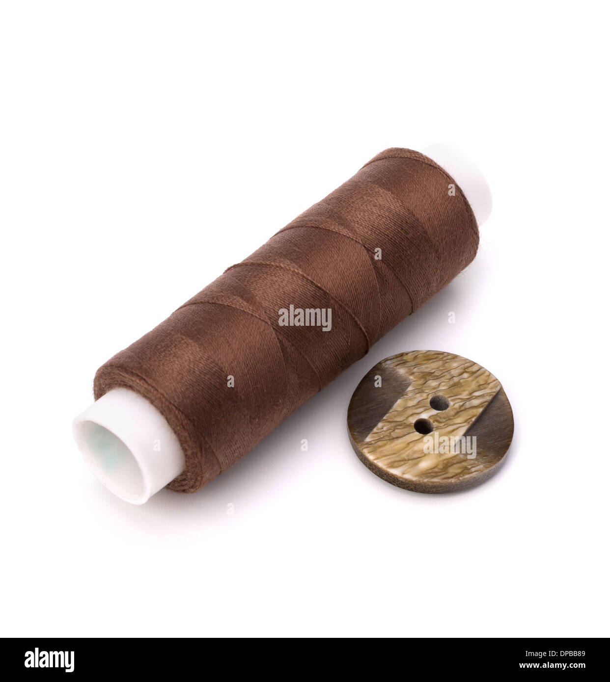 Brown spool of thread isolated on white background Stock Photo - Alamy