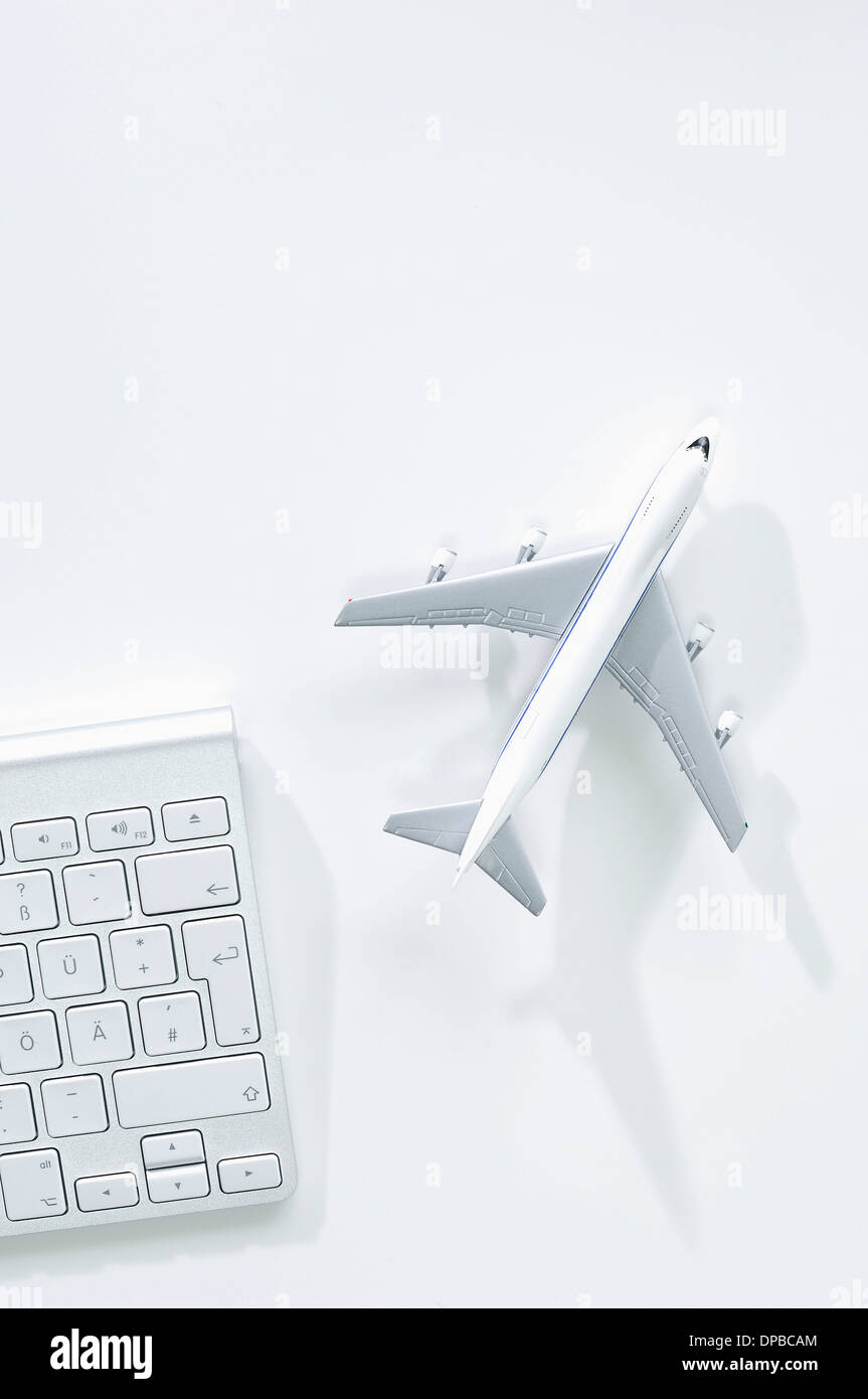 Keyboard and airplane miniature Stock Photo - Alamy