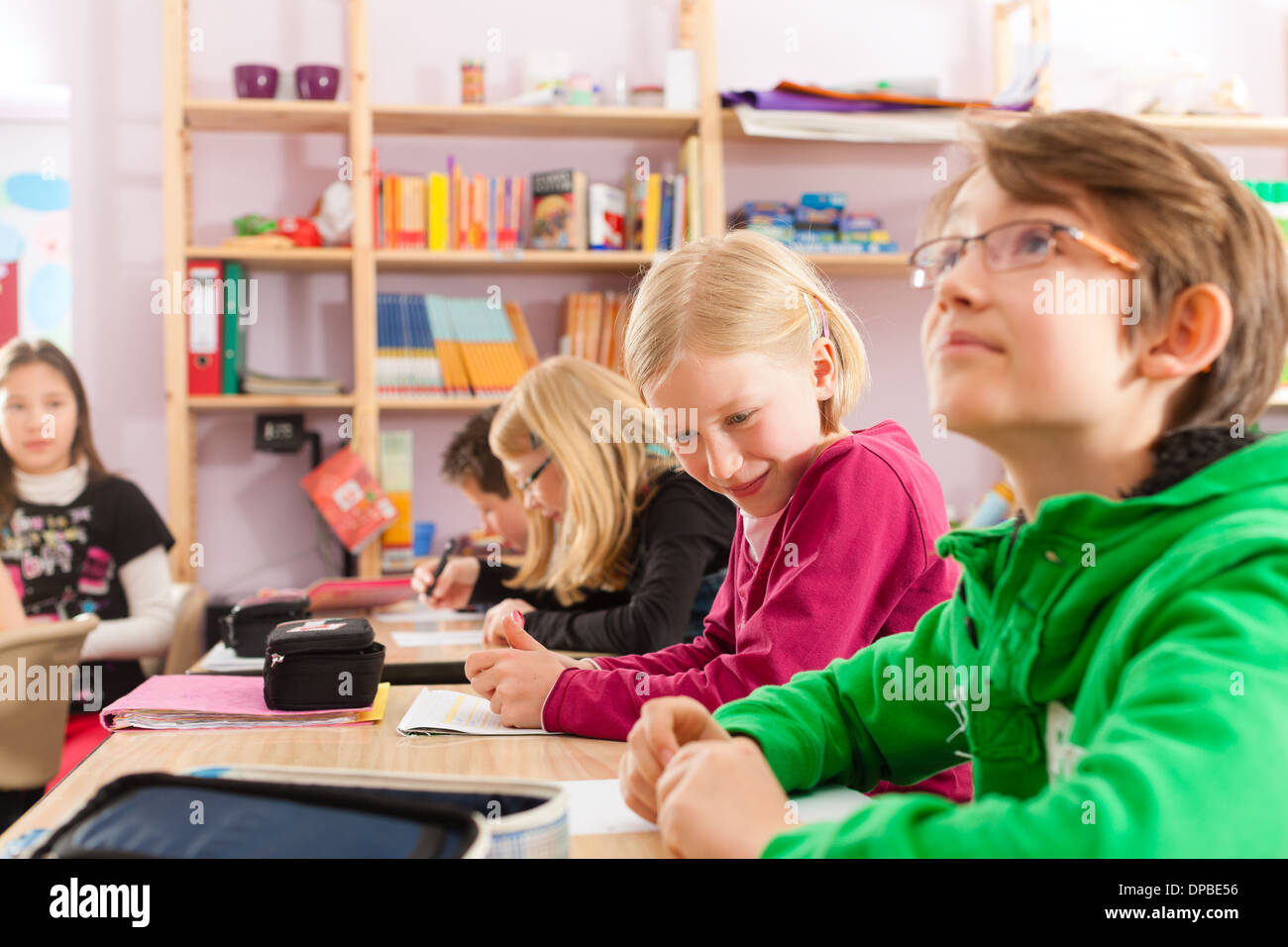 Education - Pupils at primary or elementary school doing their homework ...