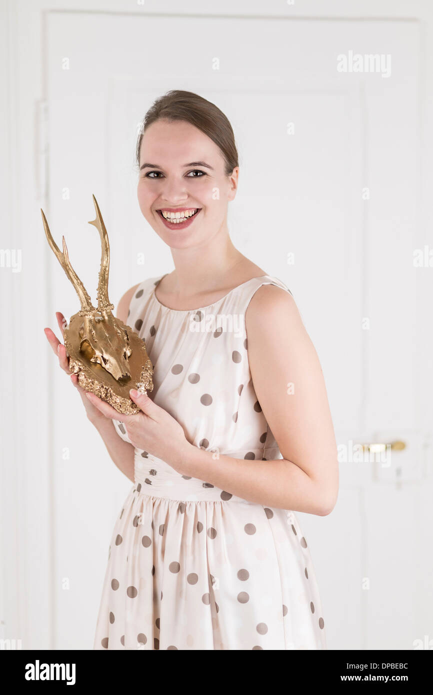 Young woman holding golden deer antlers Stock Photo - Alamy