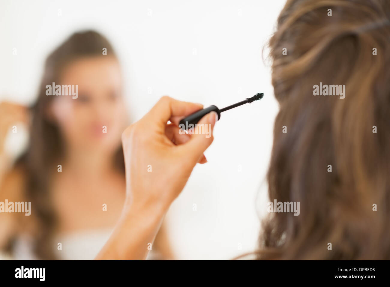 Closeup on young woman applying mascara Stock Photo - Alamy