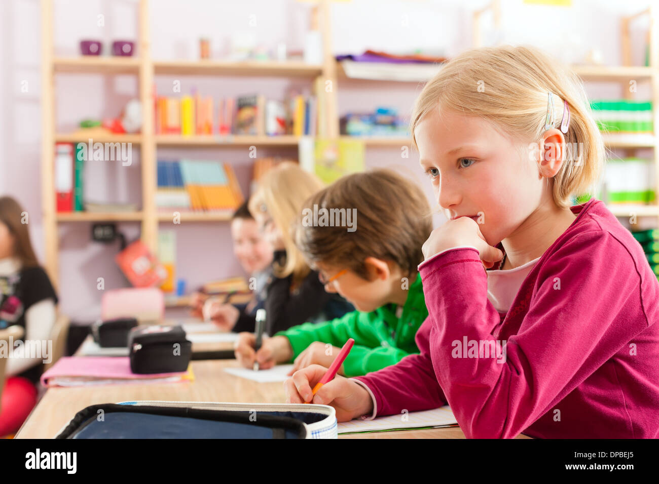 Education - Pupils at primary or elementary school doing their homework ...
