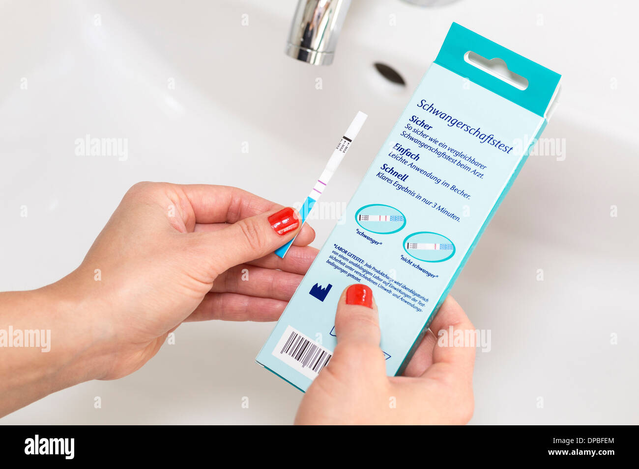 Woman doing a pregnancy test Stock Photo - Alamy