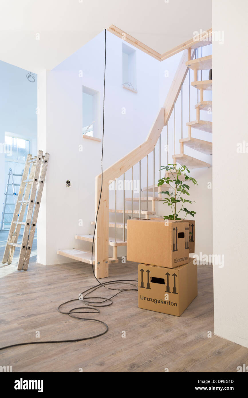 Staircase and cardboard boxes in new home Stock Photo - Alamy