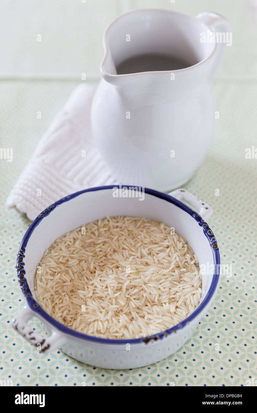 Basmati rice in pot and pitcher of water Stock Photo - Alamy