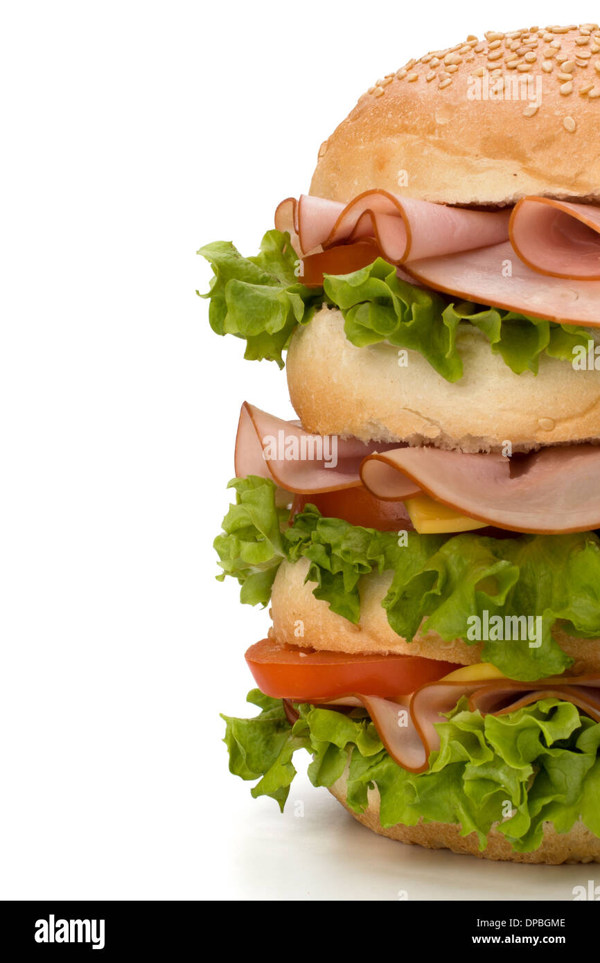 Big appetizing fast food sandwich with lettuce, tomato, smoked ham and ...