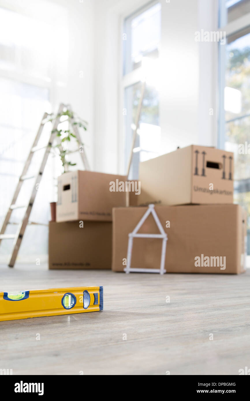 Cardboard boxes and water level in new home Stock Photo - Alamy