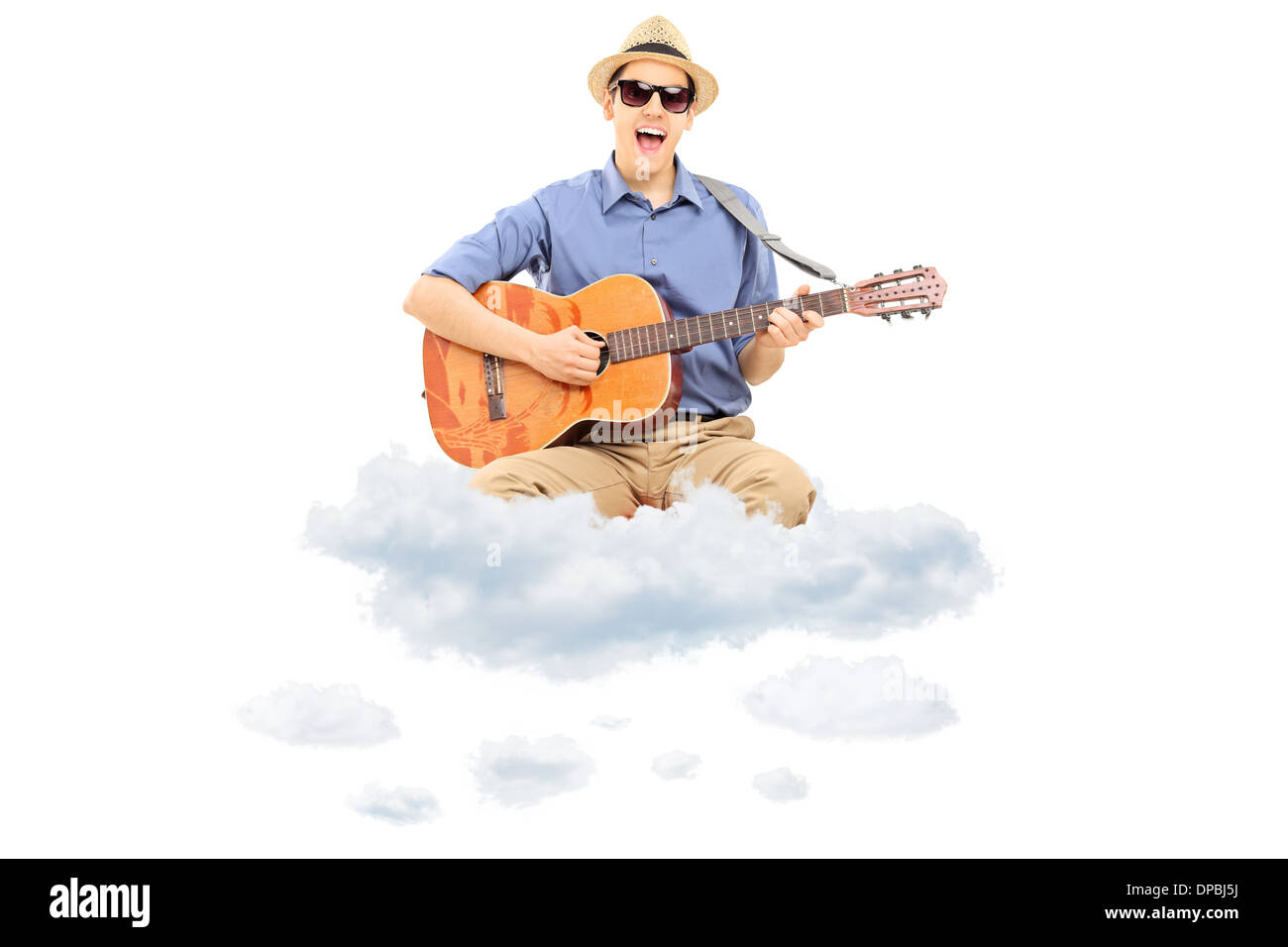 Young man playing on acoustic guitar and floating on clouds Stock Photo ...