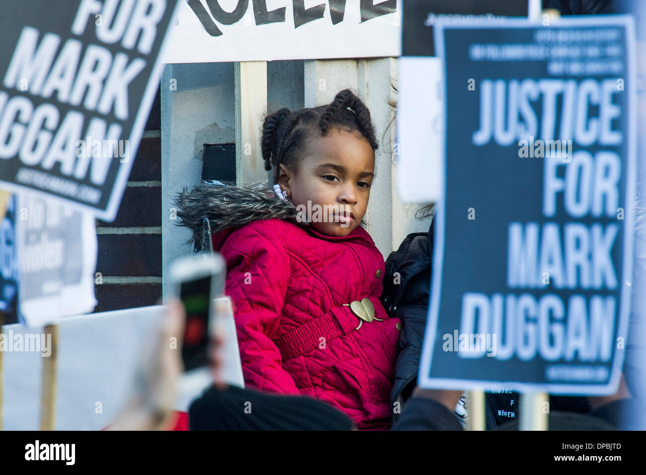 London, UK. 11th January 2014. Supporters of Mark Duggan’s family hold ...