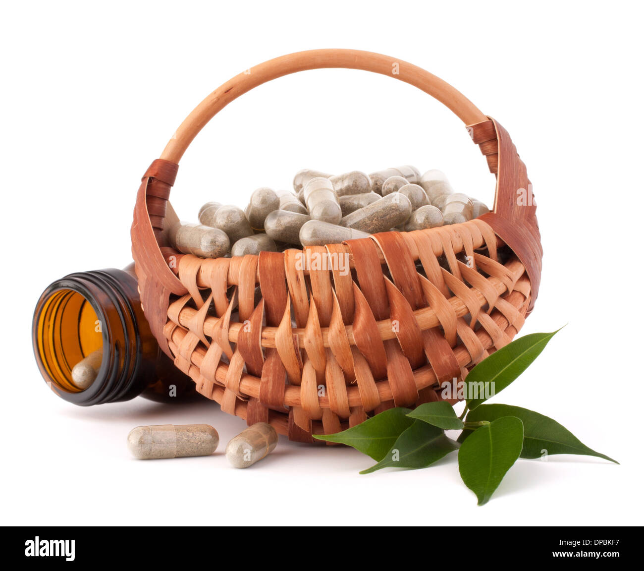 Herbal drug capsules in wicker basket isolated on white background ...