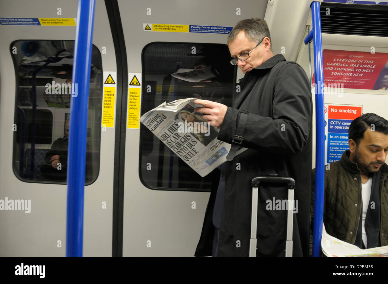 Commuter reading newspaper hi-res stock photography and images - Alamy