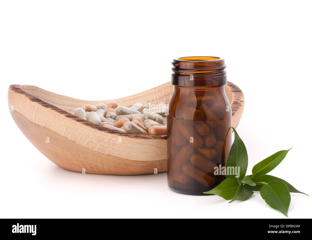 Herbal drug capsules in brown glass bottle isolated on white background ...
